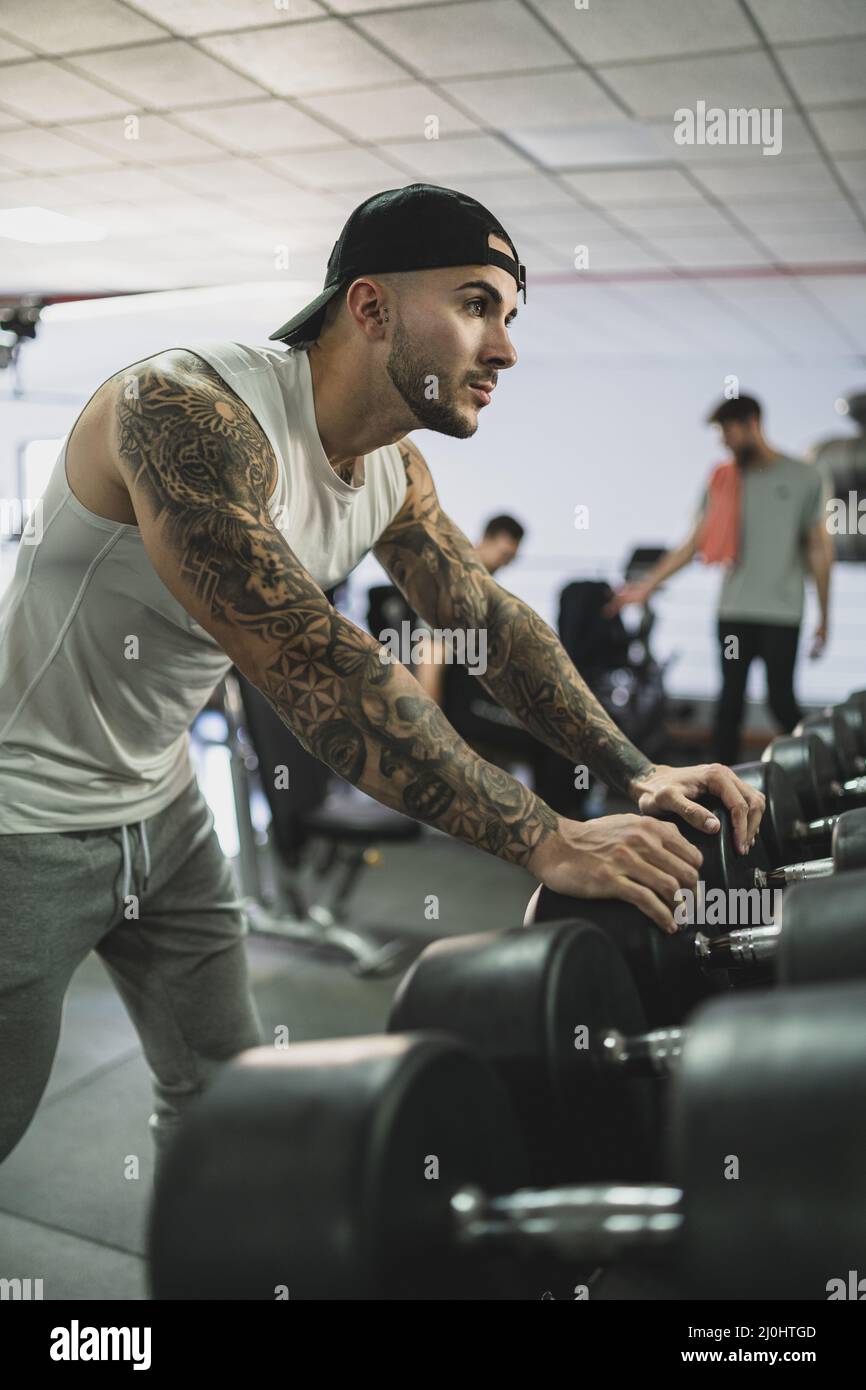 Handsome man doing a workout in the gym Stock Photo - Alamy