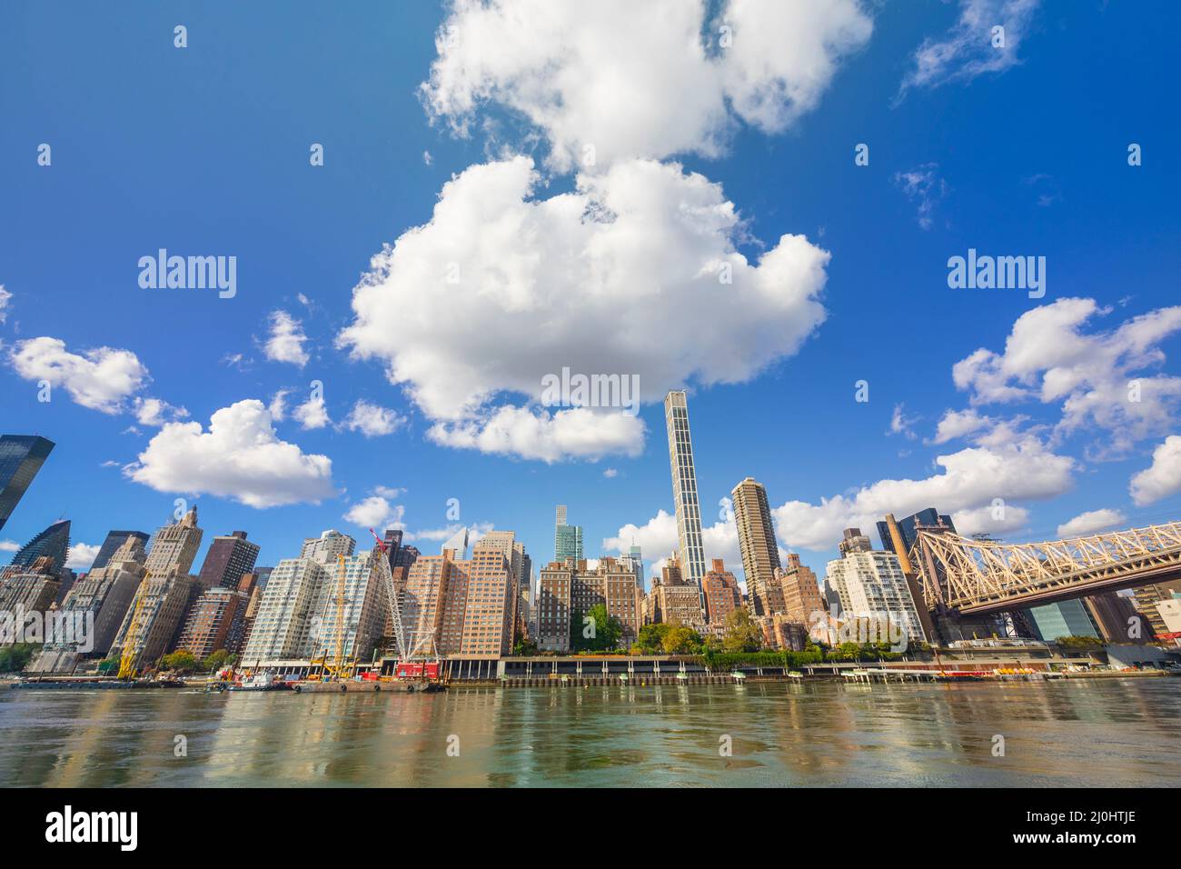 Big clouds float over the Midtown Manhattan skyscraper beyond the East ...