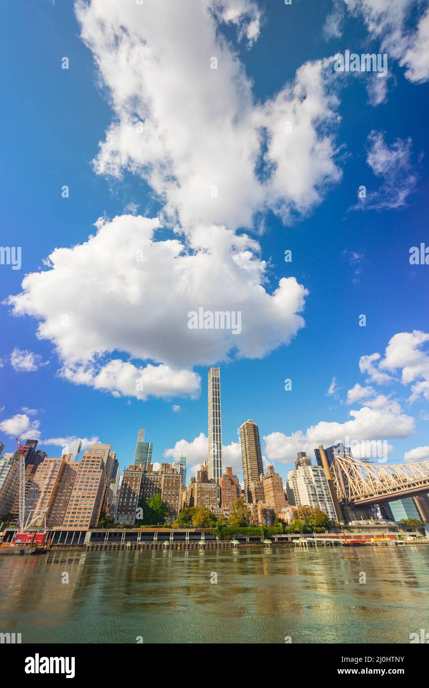 Big clouds float over the Midtown Manhattan skyscraper beyond the East ...