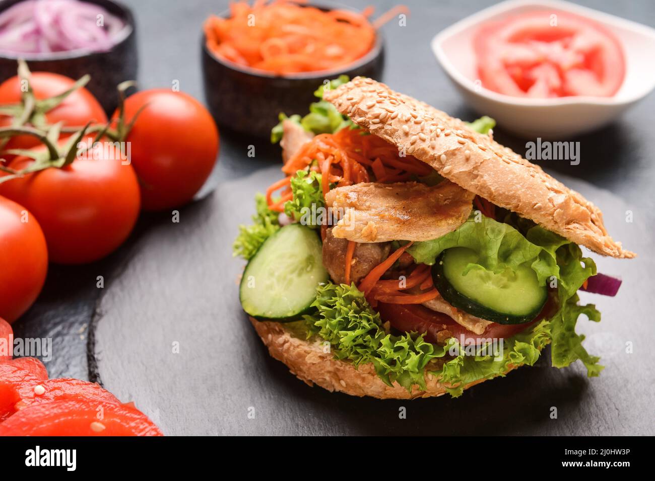 Fresh doner kebab in bun on dark background Stock Photo - Alamy