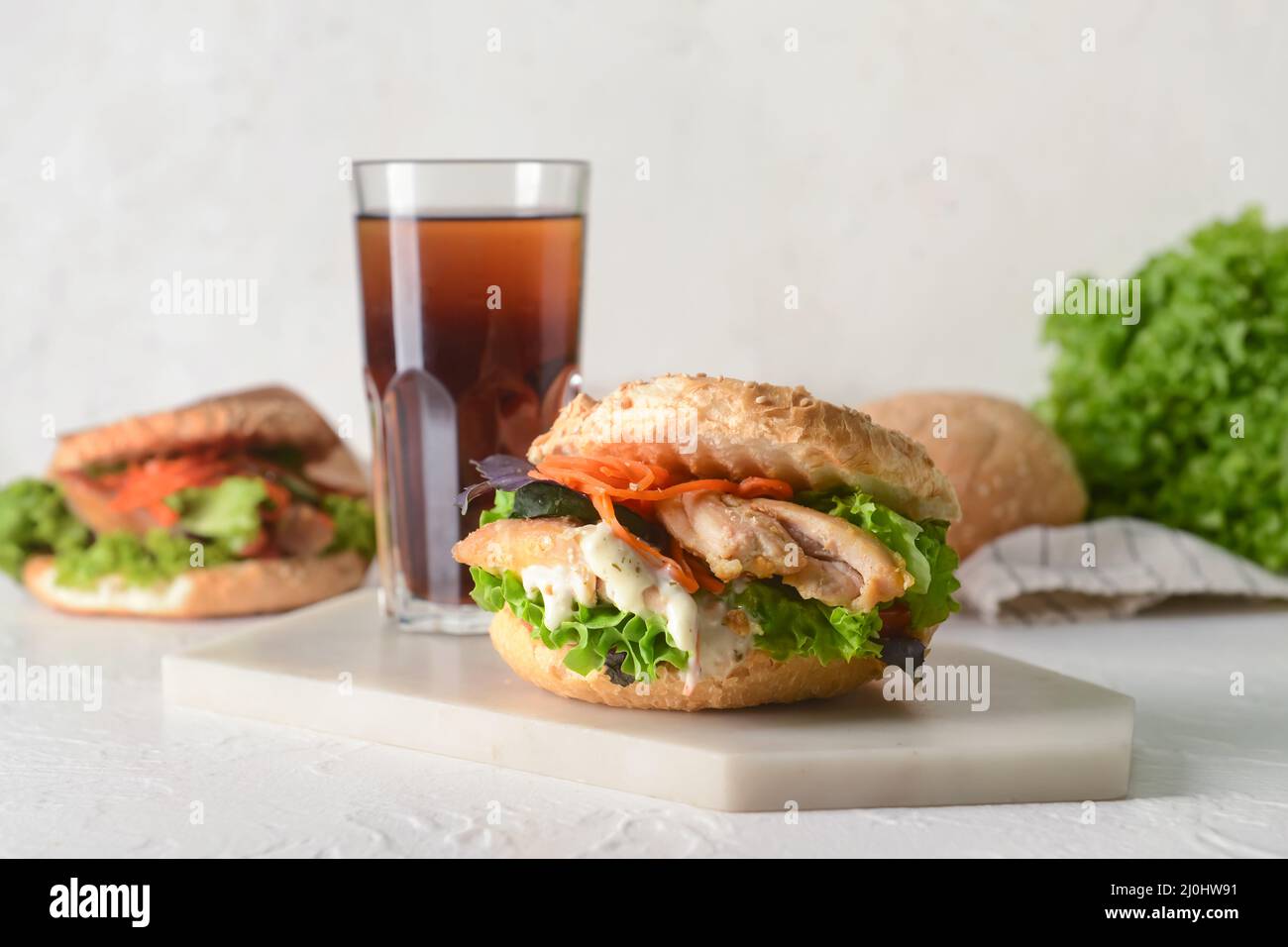 Fresh doner kebab in bun with glass of cola drink on white background ...