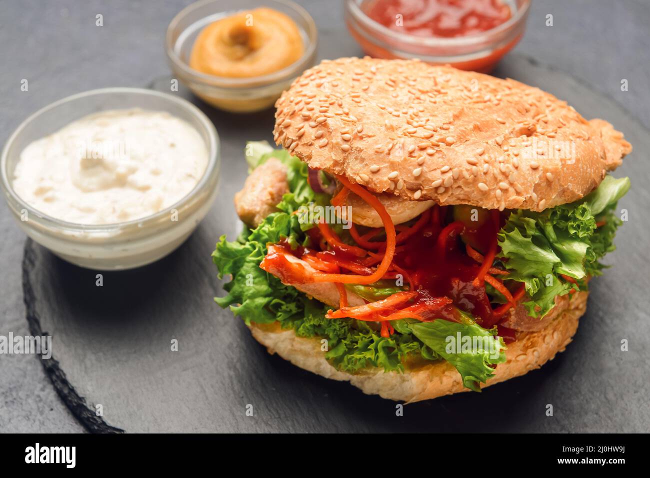 Fresh doner kebab in bun with sauces on dark background Stock Photo - Alamy