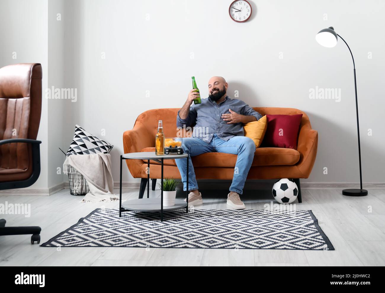 Funny lazy man drinking beer and watching football at home Stock Photo ...