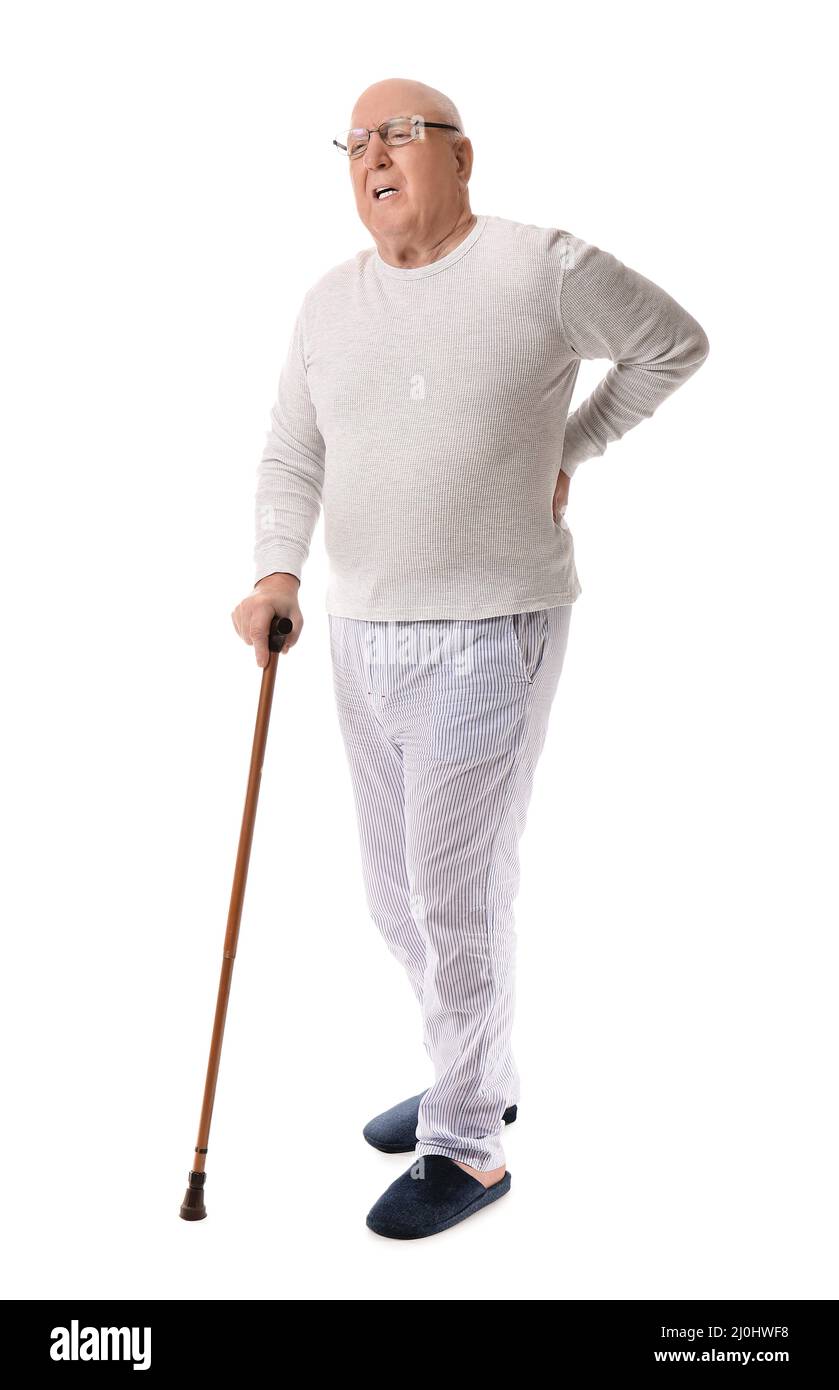 Senior man with walking stick suffering from back pain on white ...