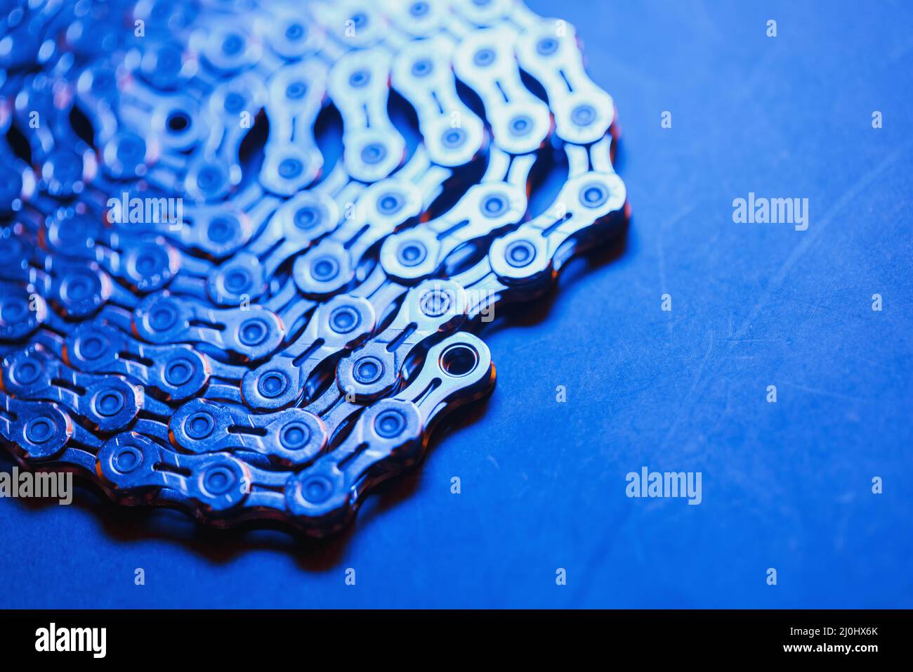 Patterns of a technological bicycle chain braided in a circle with blue ...