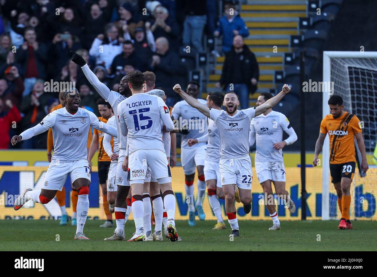 The Luton Town players celebrate their third goal scored by James Bree ...