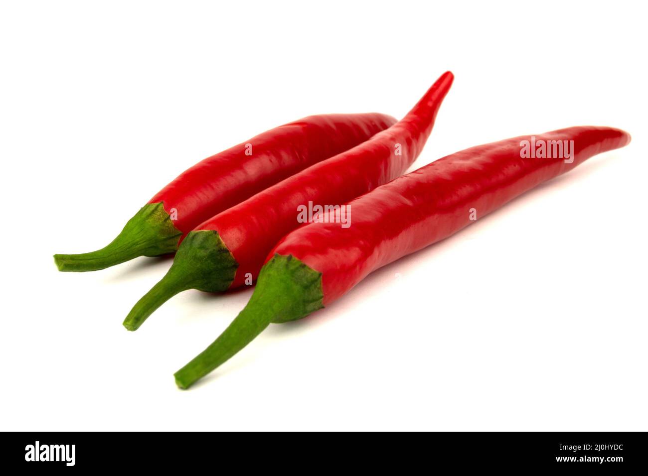 Three Chili peppers isolated on a white background Stock Photo - Alamy