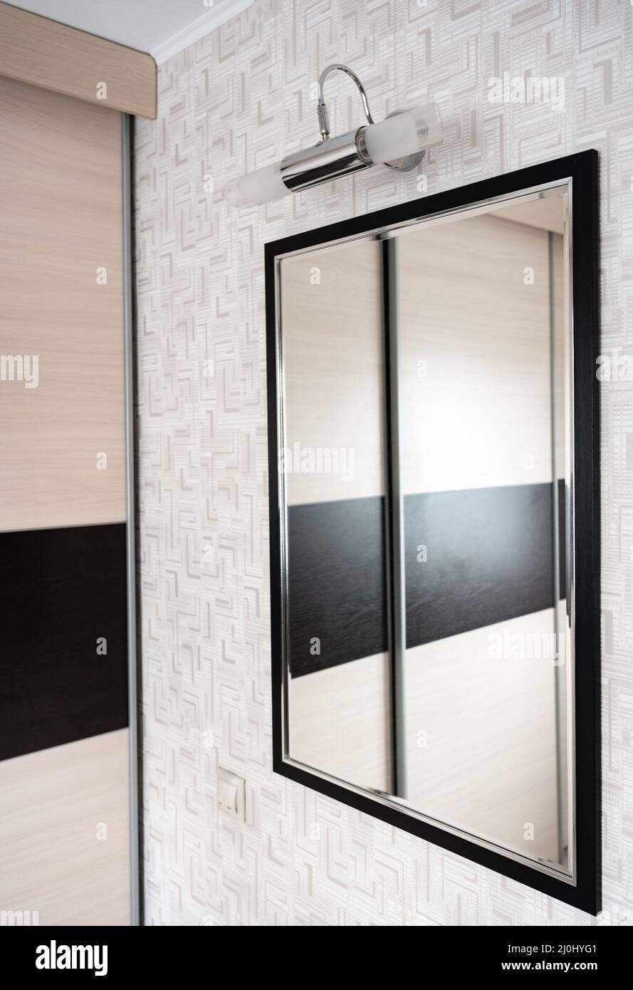 Mirror on the wall with light Stock Photo - Alamy