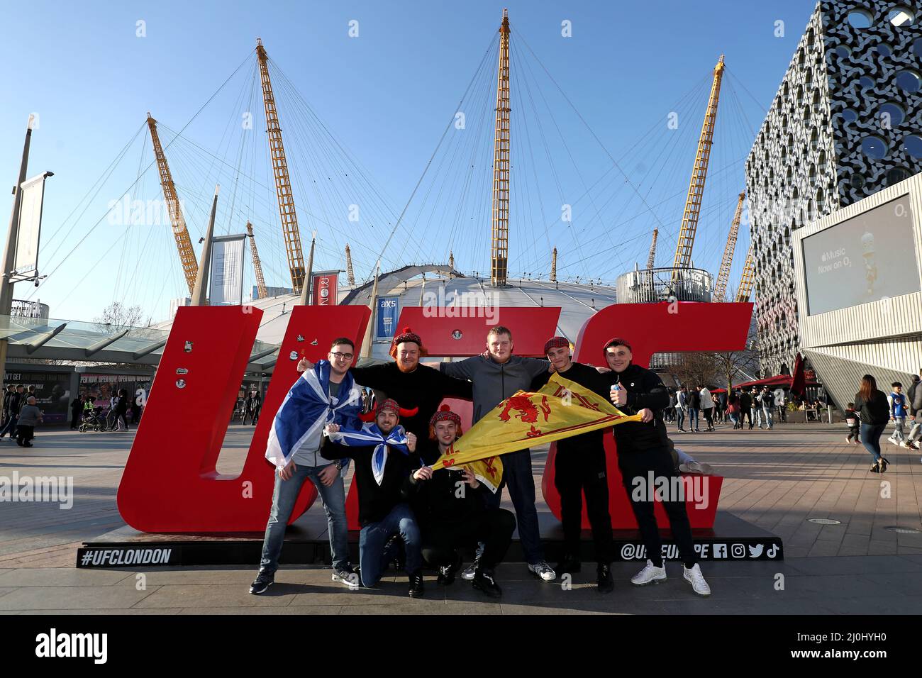 Fans pose by UFC signage outside The O2, London before the UFC Fight ...
