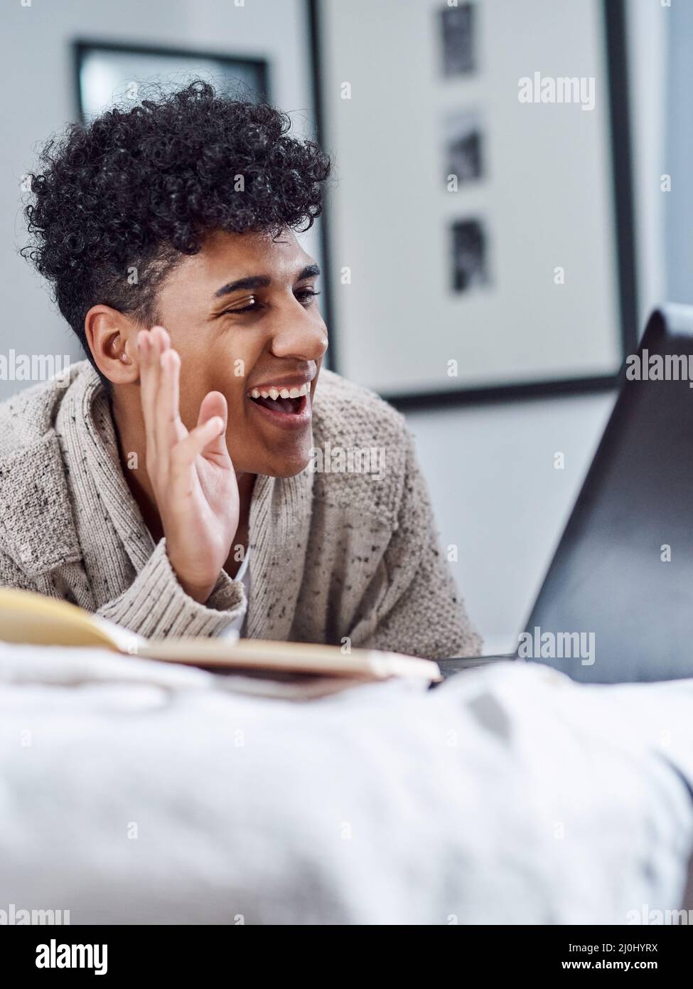 Lectures online save time. Shot of a young man using a laptop to have a ...