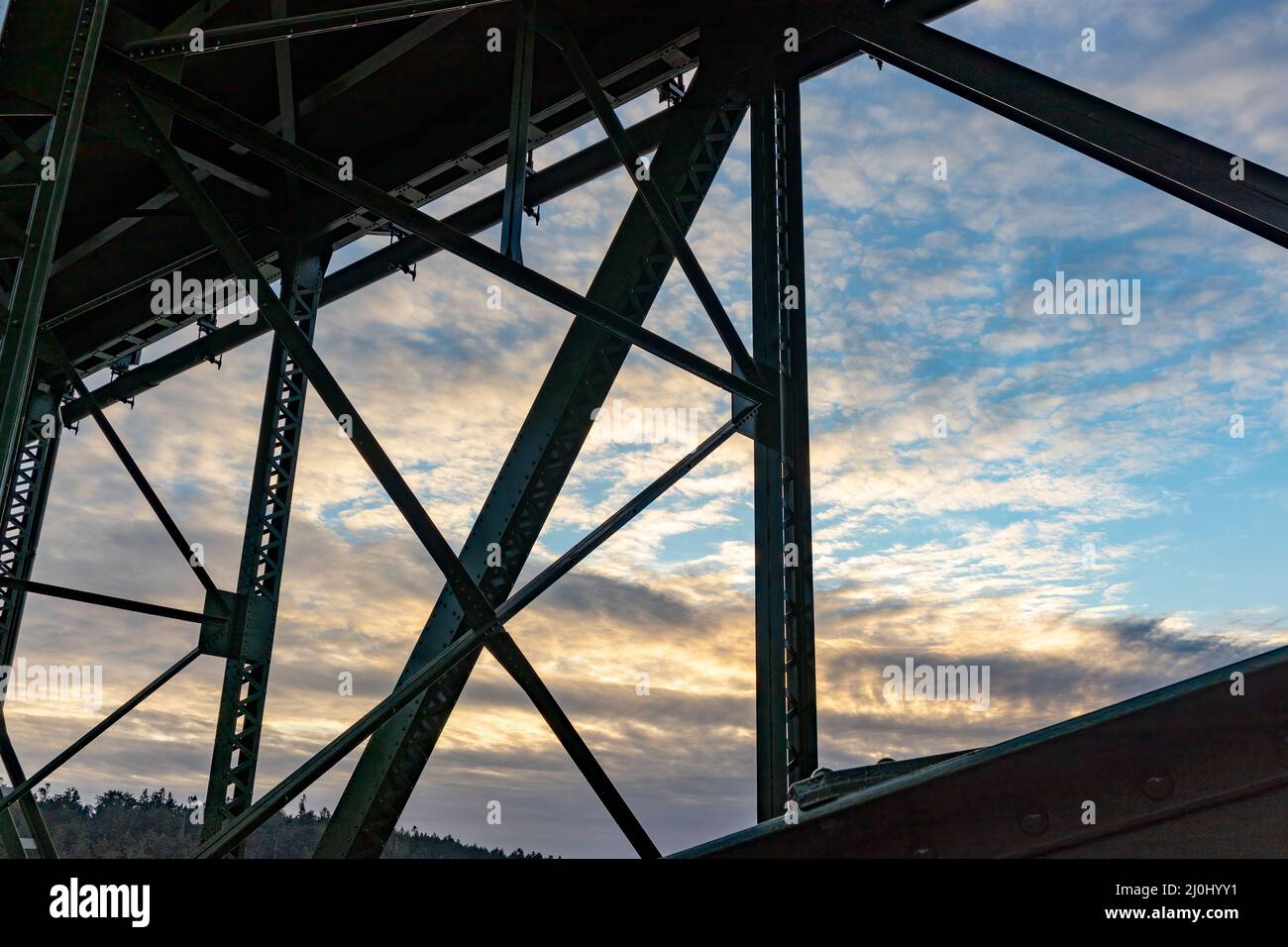 an old green bridge crossing from one cliff to another Stock Photo - Alamy