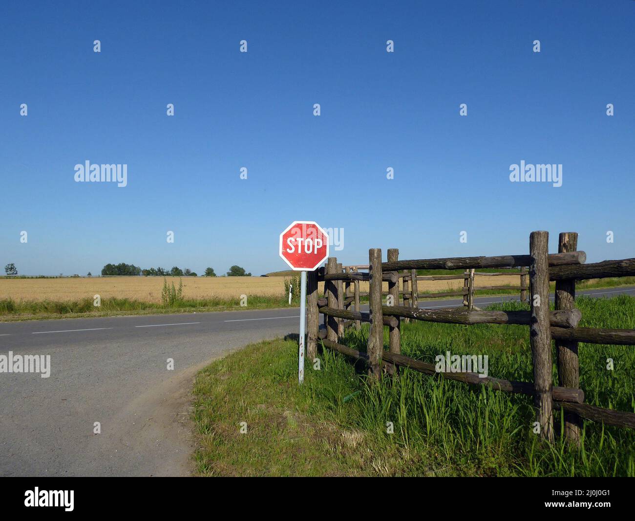 Red stop sign at the end of a country road at an intersection Stock ...