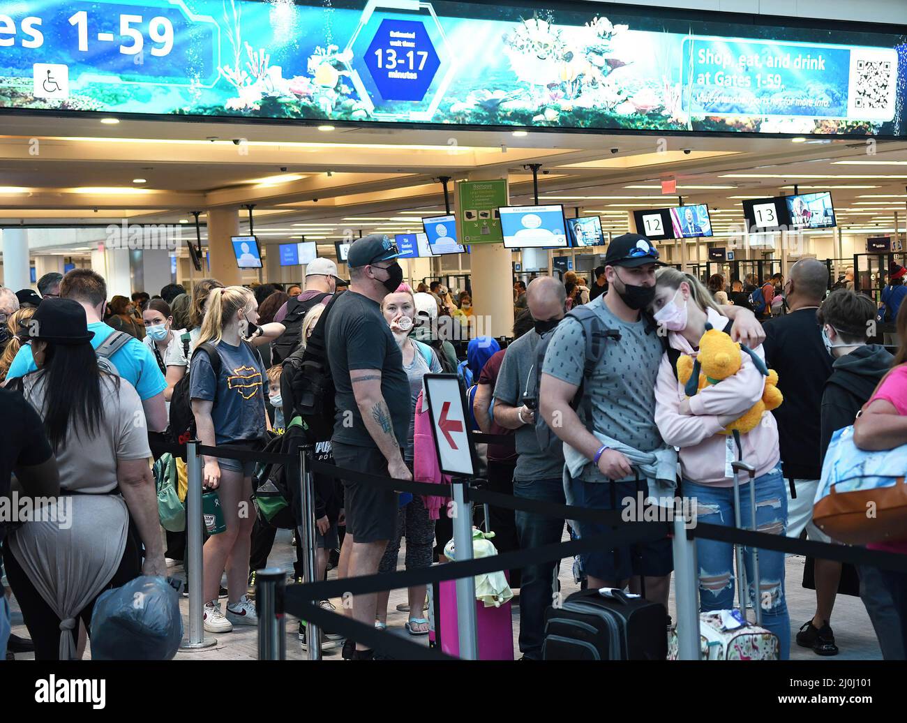 Spring break passengers wait in a TSA security line at Orlando ...