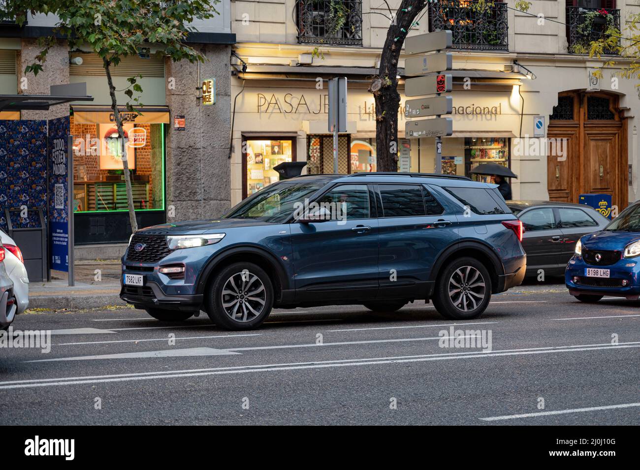 Large modern blue Ford Explorer car driving through the streets of ...
