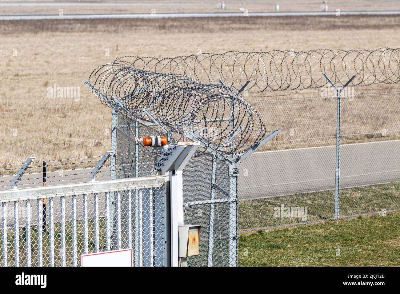 a barbed wire fence to protect a border Stock Photo - Alamy