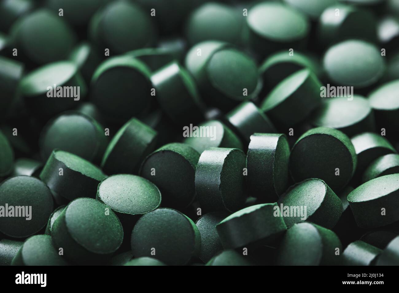 Close-up of Green tablets of organic spirulina as a texture background ...
