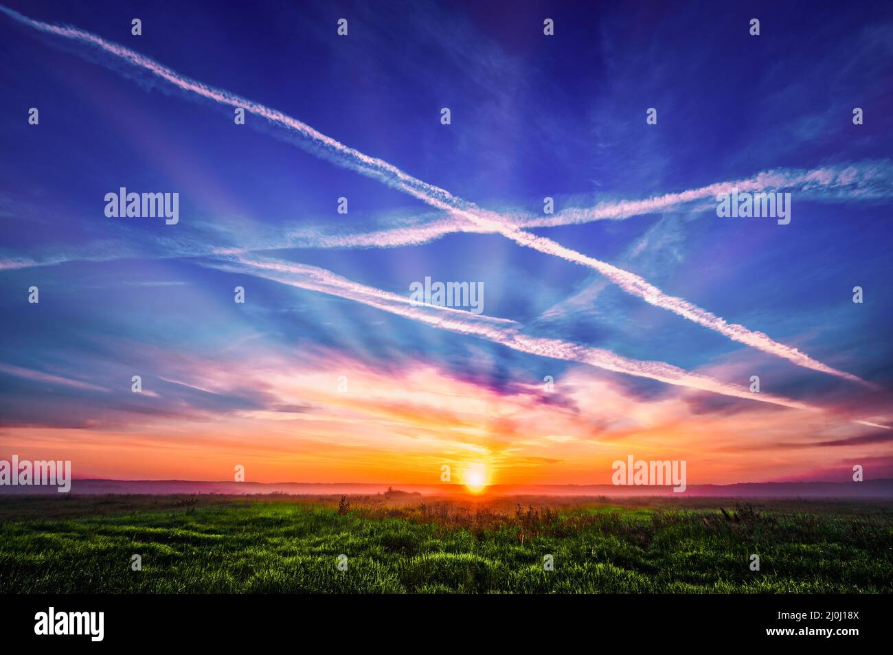 The sun's rays in the field at sunrise Stock Photo - Alamy