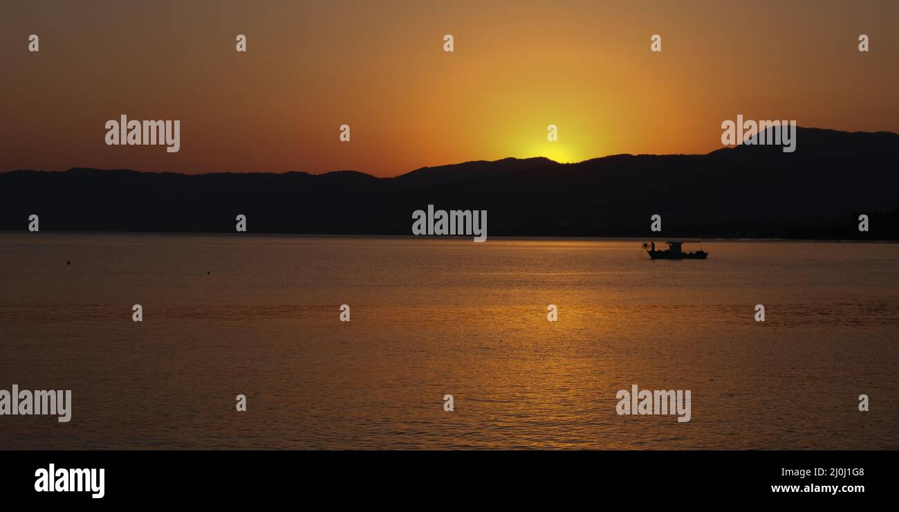 Fishing boat sailing in the sea to catch fish at sunrise Stock Photo ...