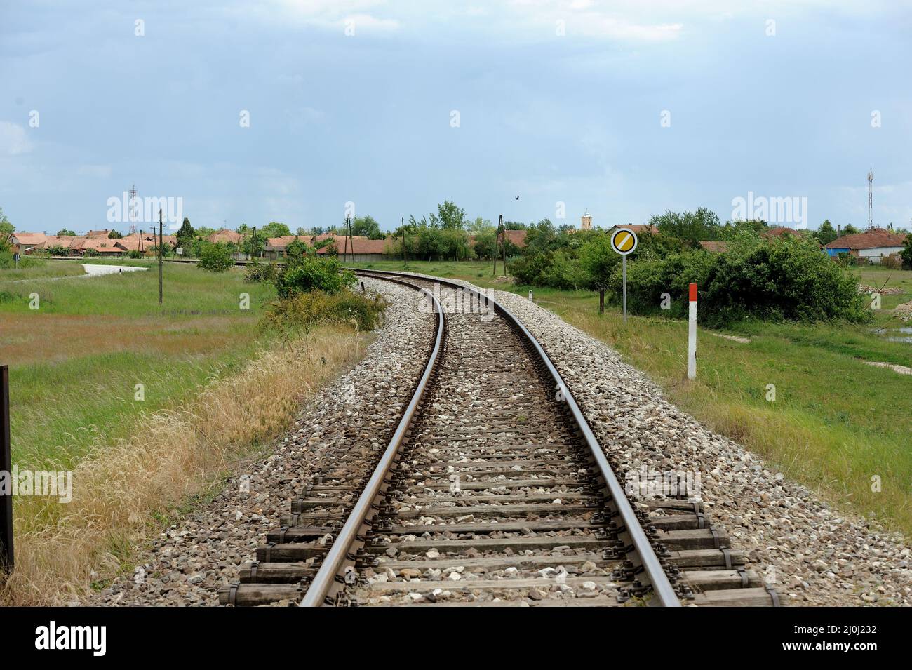 Rural railroad through a green field Stock Photo - Alamy