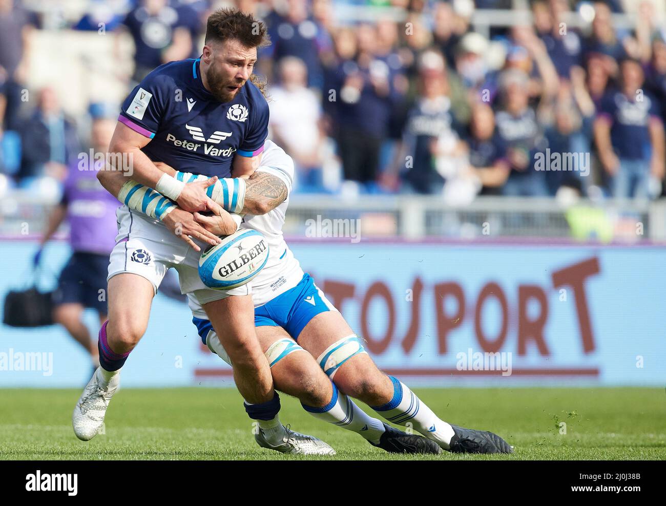 Rome, Italy. 12 March, 2022. Ali Price of Scotland is tackled by ...