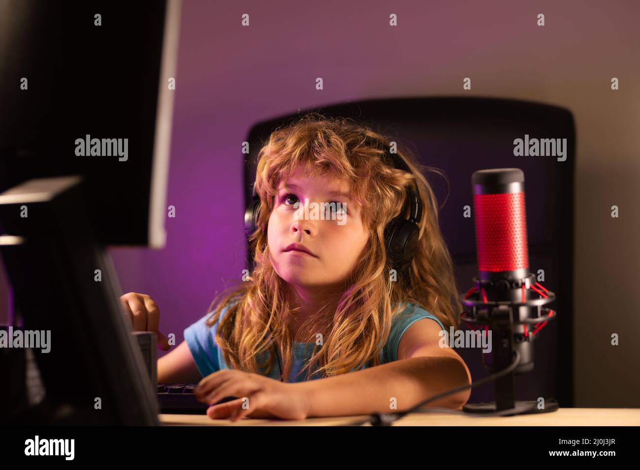 Kid using pc at night. Child with computer in a dark room. School ...