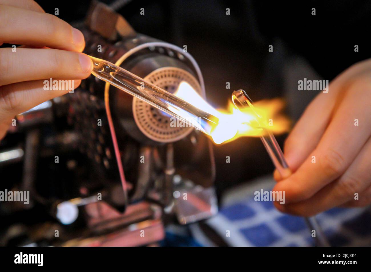 Glass sticks are heated in order to process them artistically Stock ...
