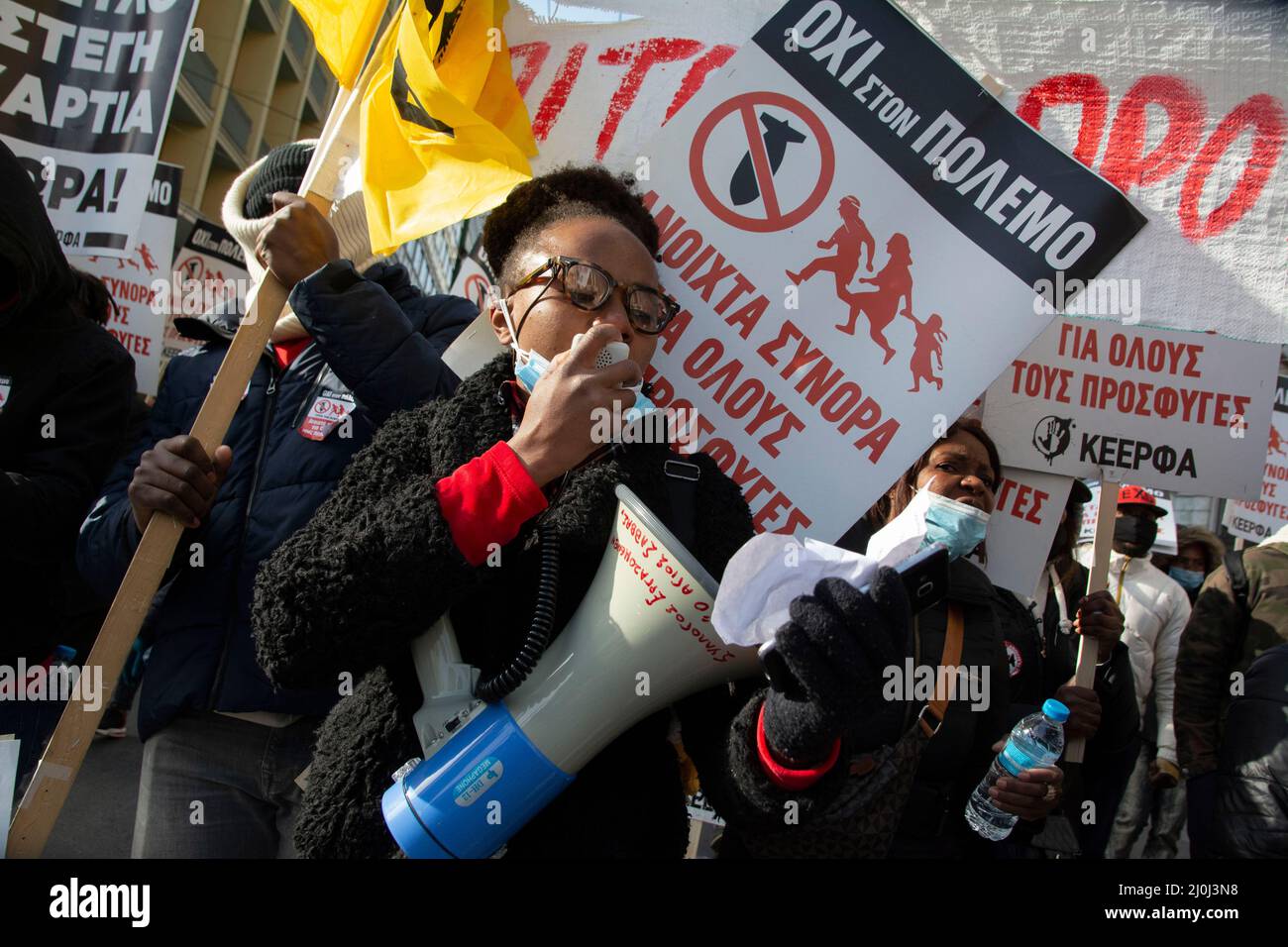 March 19, 2022: Protesters hold banners and placards and march shouting ...