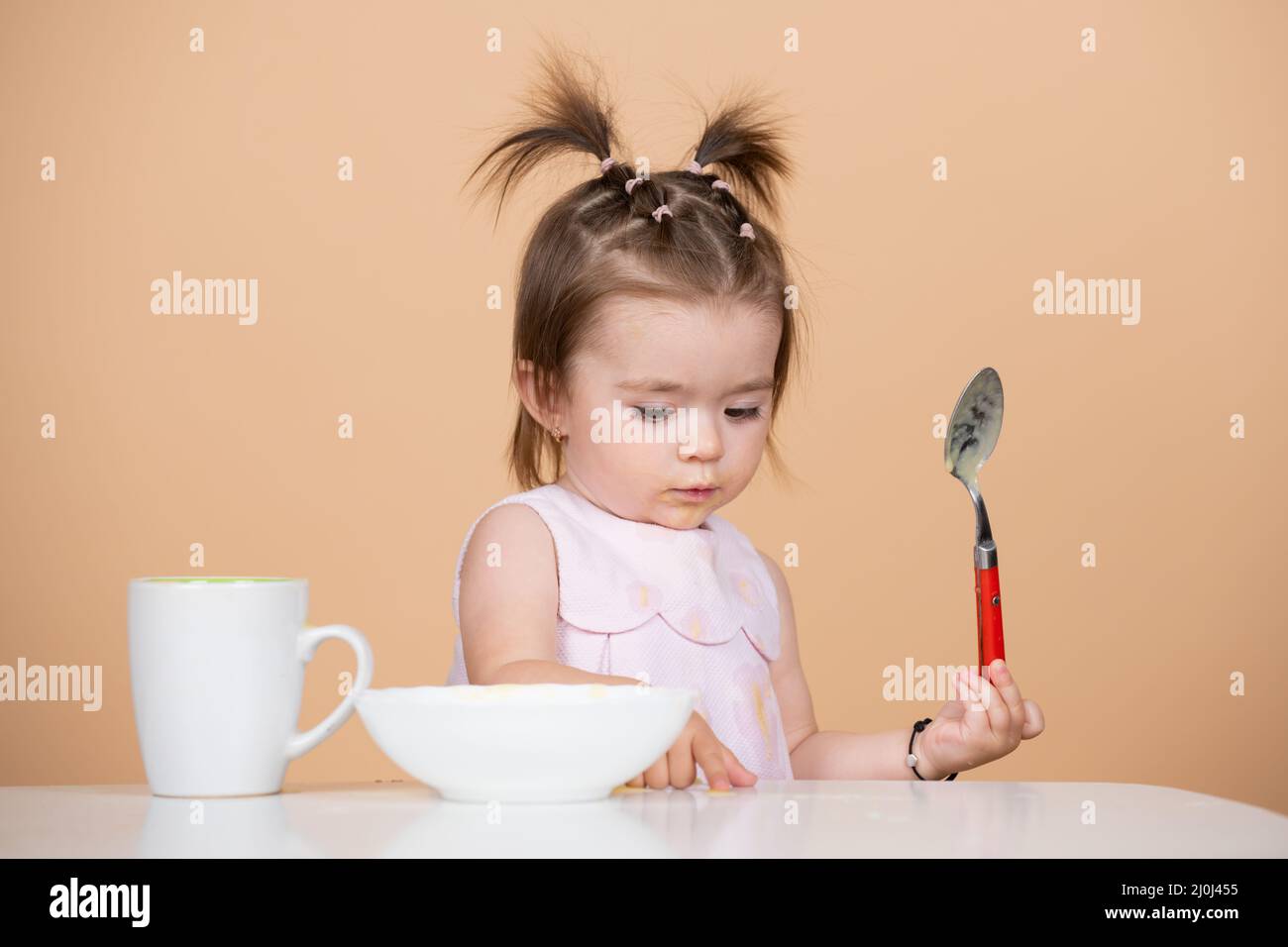 Baby food, babies eating. Portrait of cute Caucasian child kid with ...