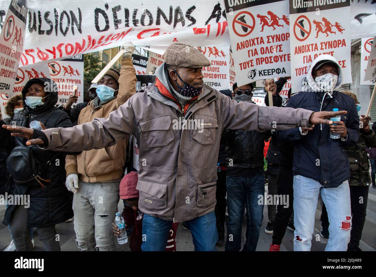March 19, 2022: Protesters hold banners and placards and march shouting ...