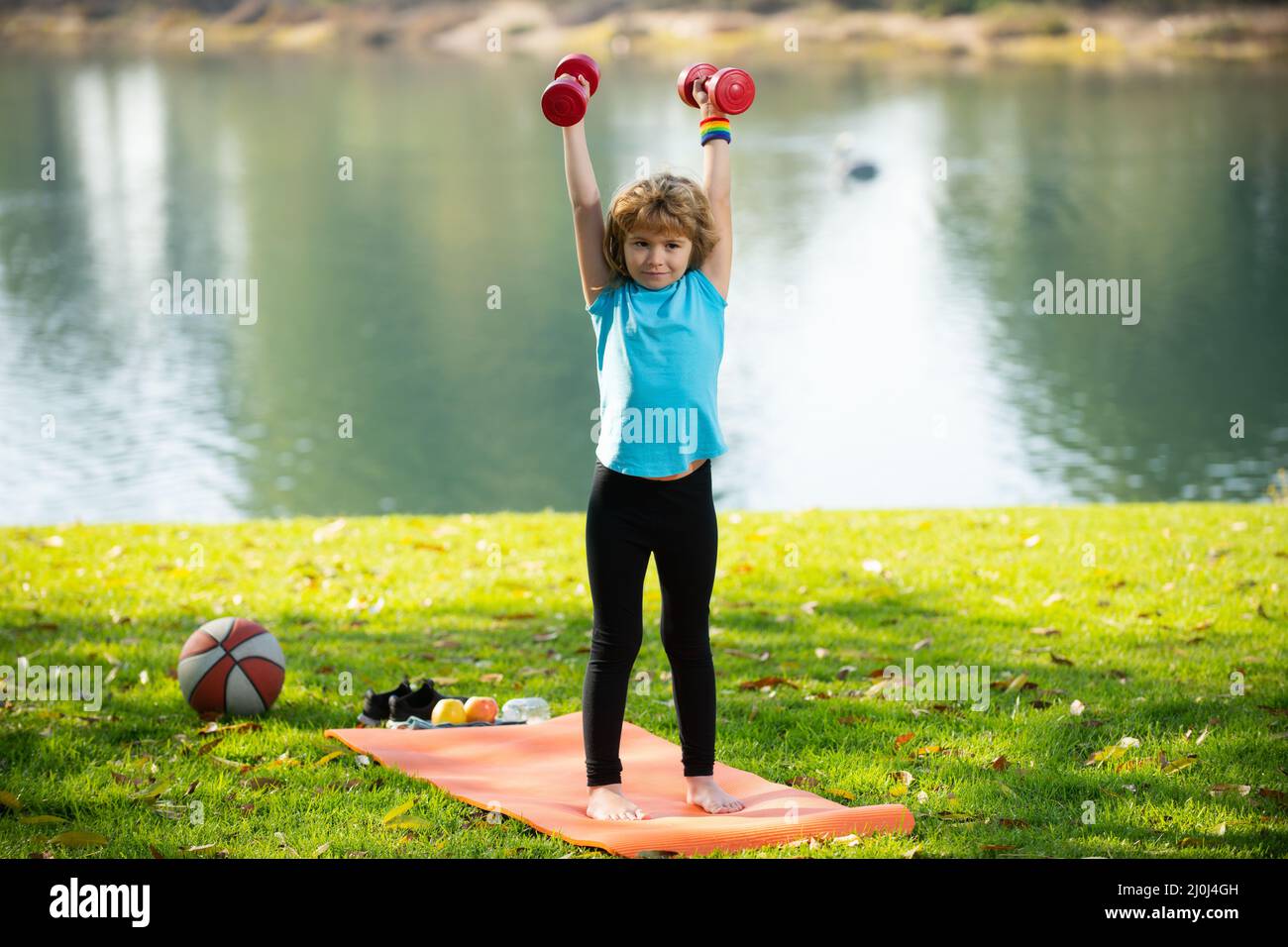 Sport children. Kids exercising fitness dumbbells. Strong little boy ...