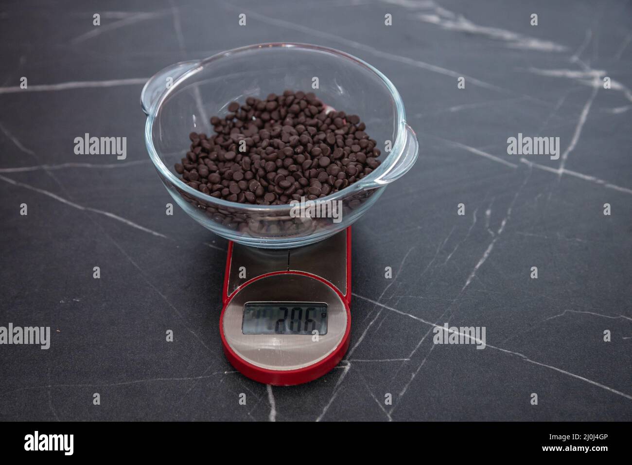 Glass bowl with chocolate chips on a scale on a kitchen table Stock ...