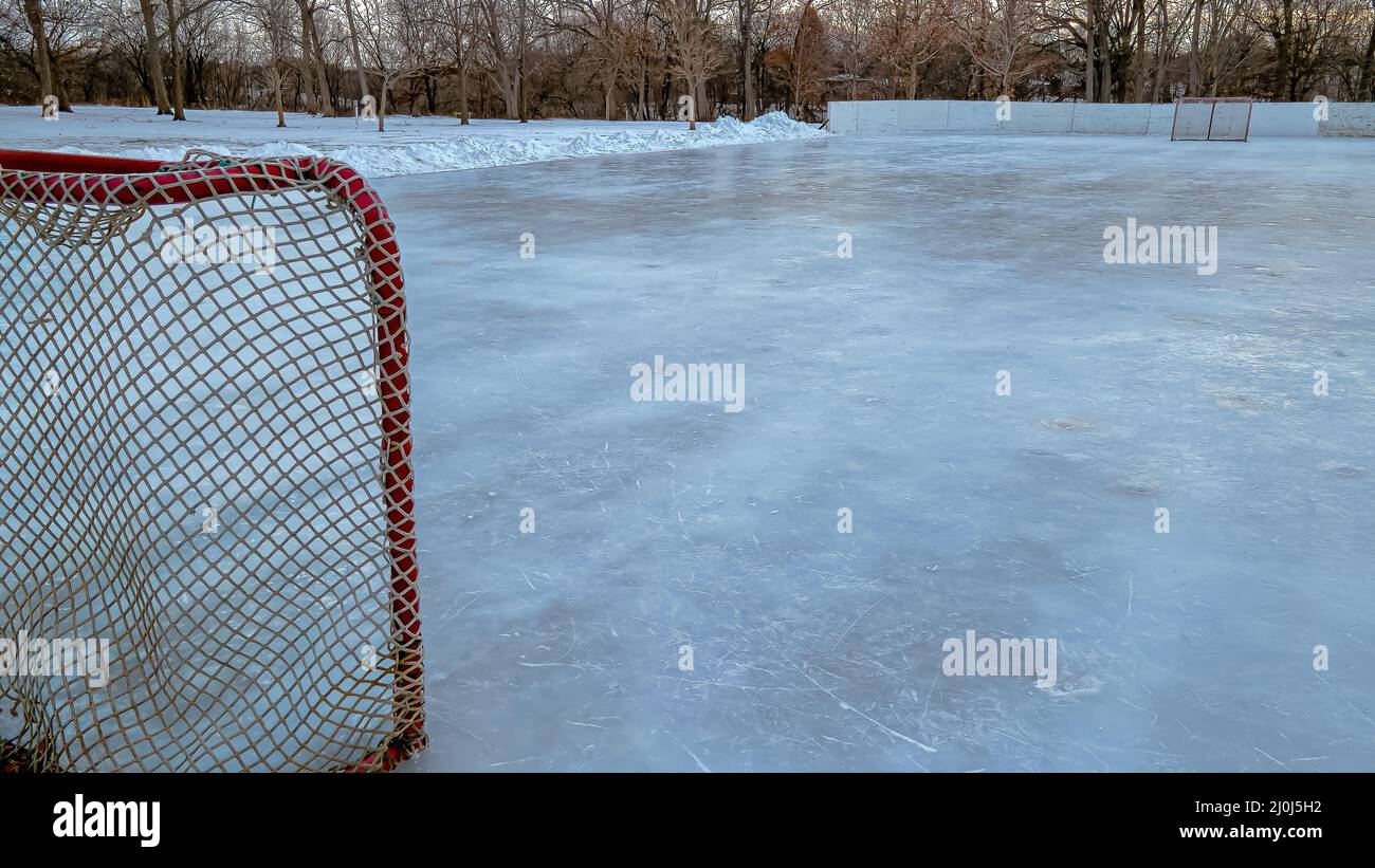 A bright red hockey net on a outdoors ice rink Stock Photo - Alamy