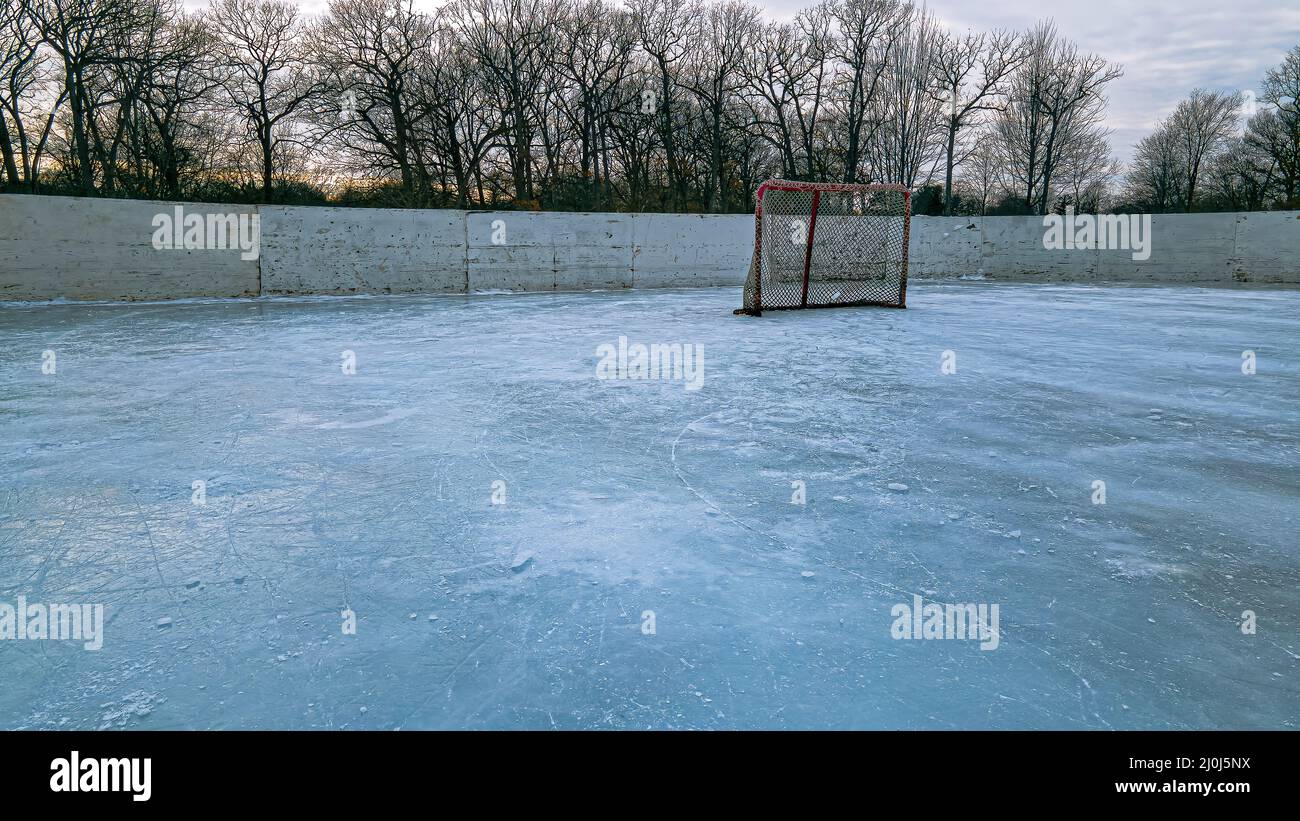 A bright red hockey net on a outdoors ice rink Stock Photo - Alamy