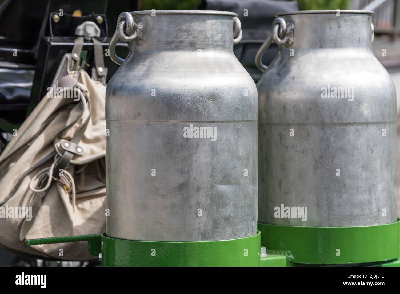 Nostalgic milk cans and old hiking backpack - dairy farming Stock Photo ...
