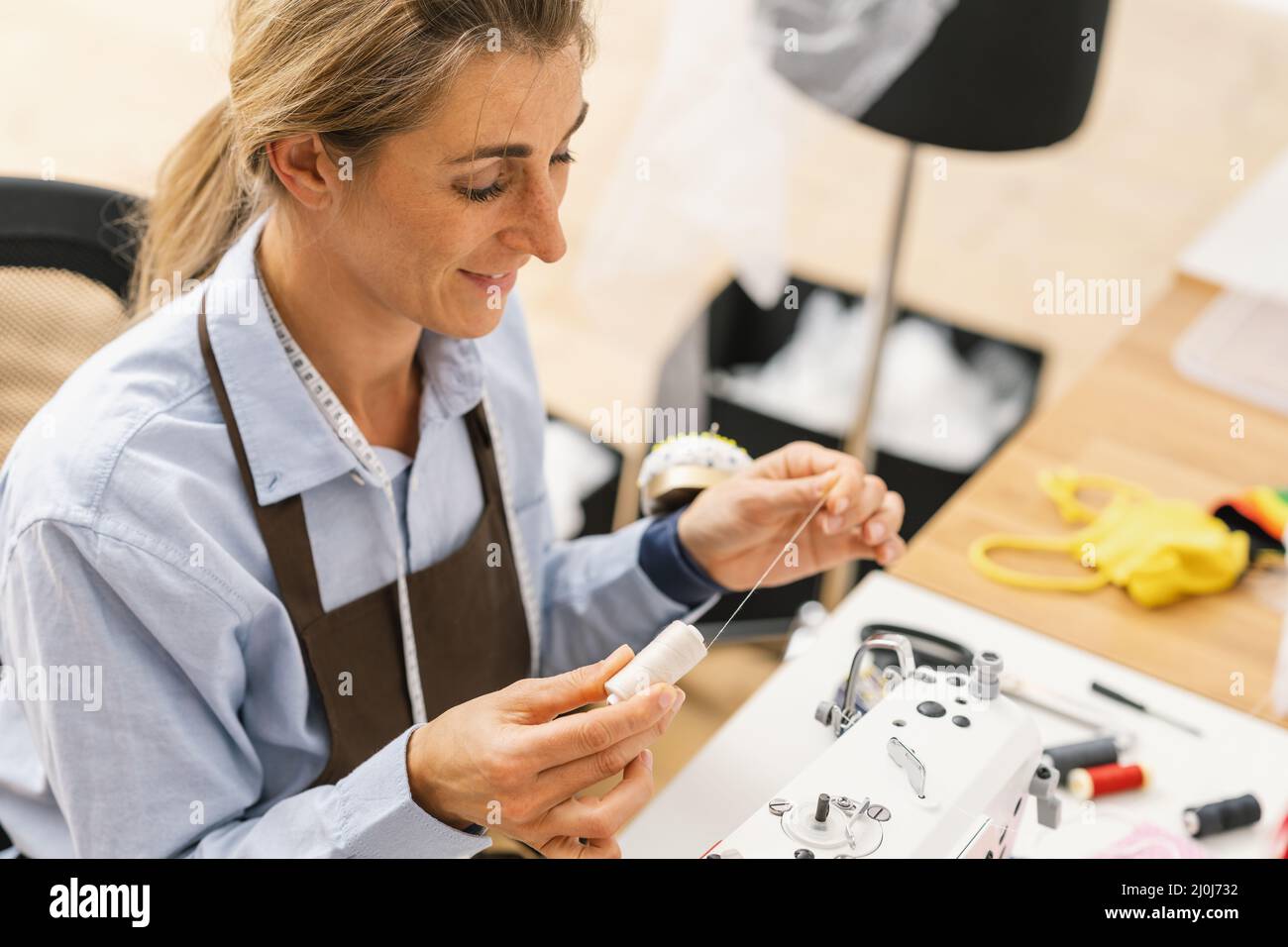 Sewer sews clothes on sewing hi-res stock photography and images - Alamy