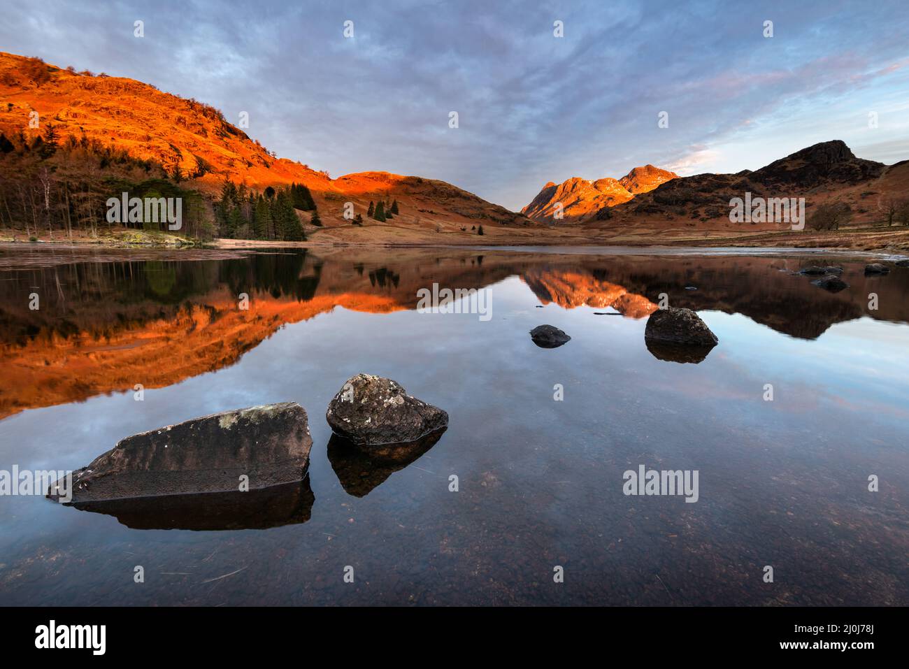 Reflections in lake at sunrise on a Winter morning at Blea Tarn in the ...