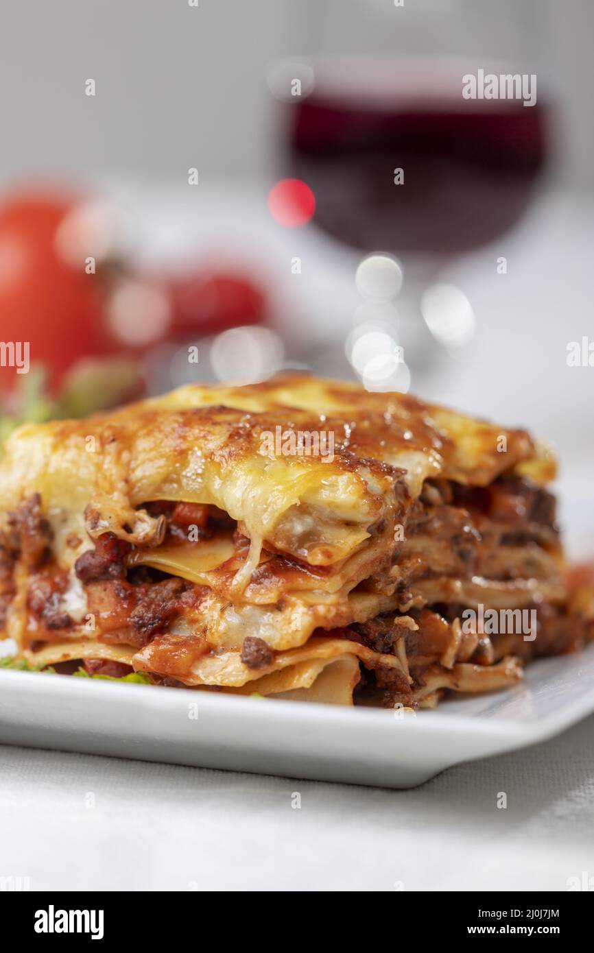 Serving lasagna on a plate Stock Photo - Alamy