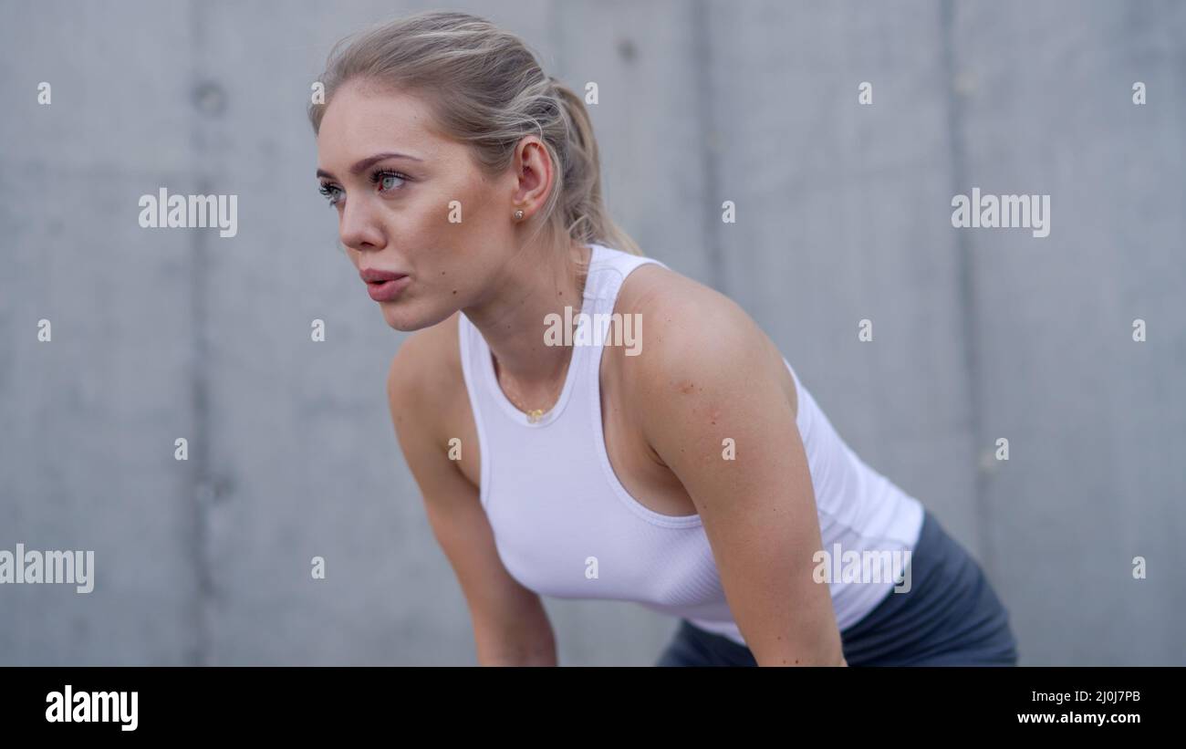 Exhausted female athlete taking break hi-res stock photography and ...