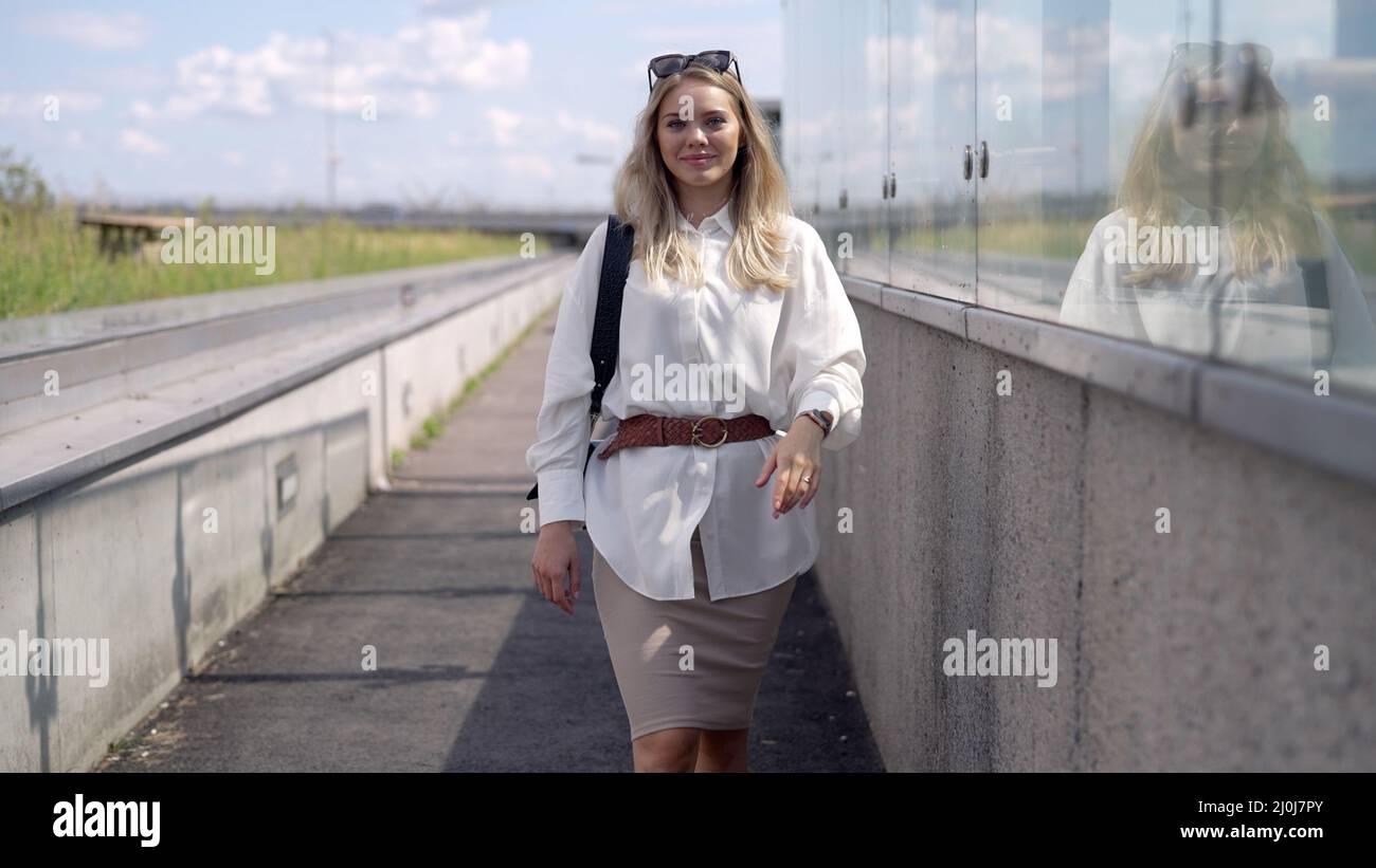 Woman walking outside building hi-res stock photography and images - Alamy