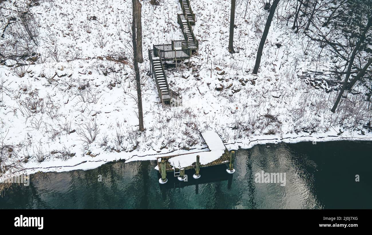 A steep set of stairs going to the river in winter. The cold causes the ...