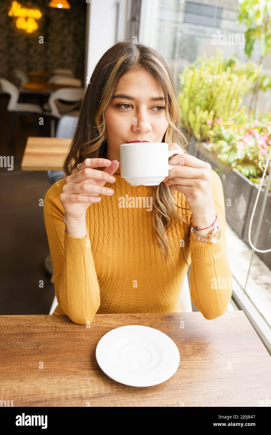 beauty and lifestyle with hot drink, beautiful, young, latin woman with ...