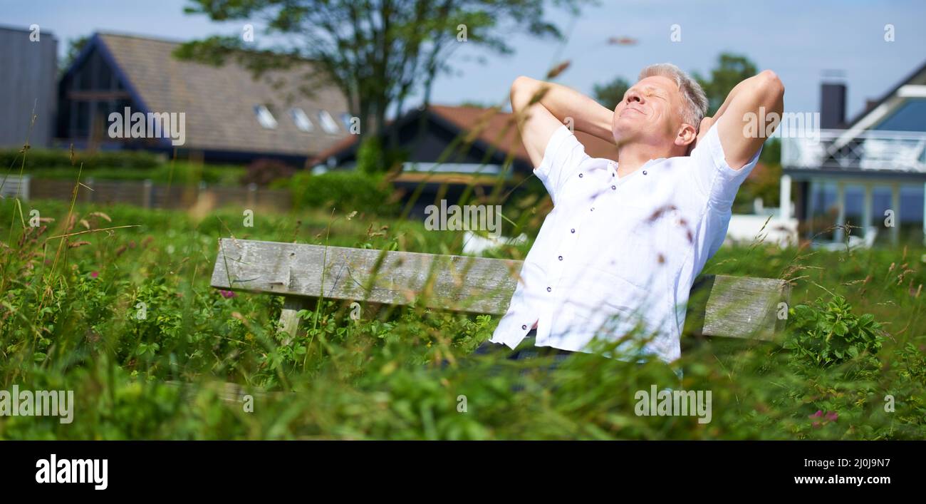 Reveling in nature. A senior man relaxing on a park bench Stock Photo ...