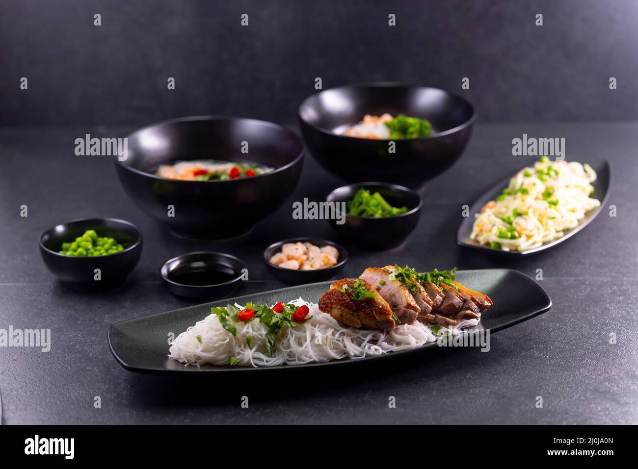 Various dishes of Asian cuisine with different types noodles and rice ...