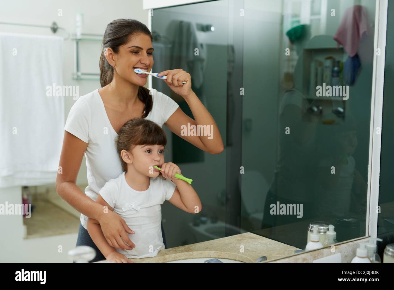 Love is, helping them learn healthy dental habits. Shot of a mother and ...