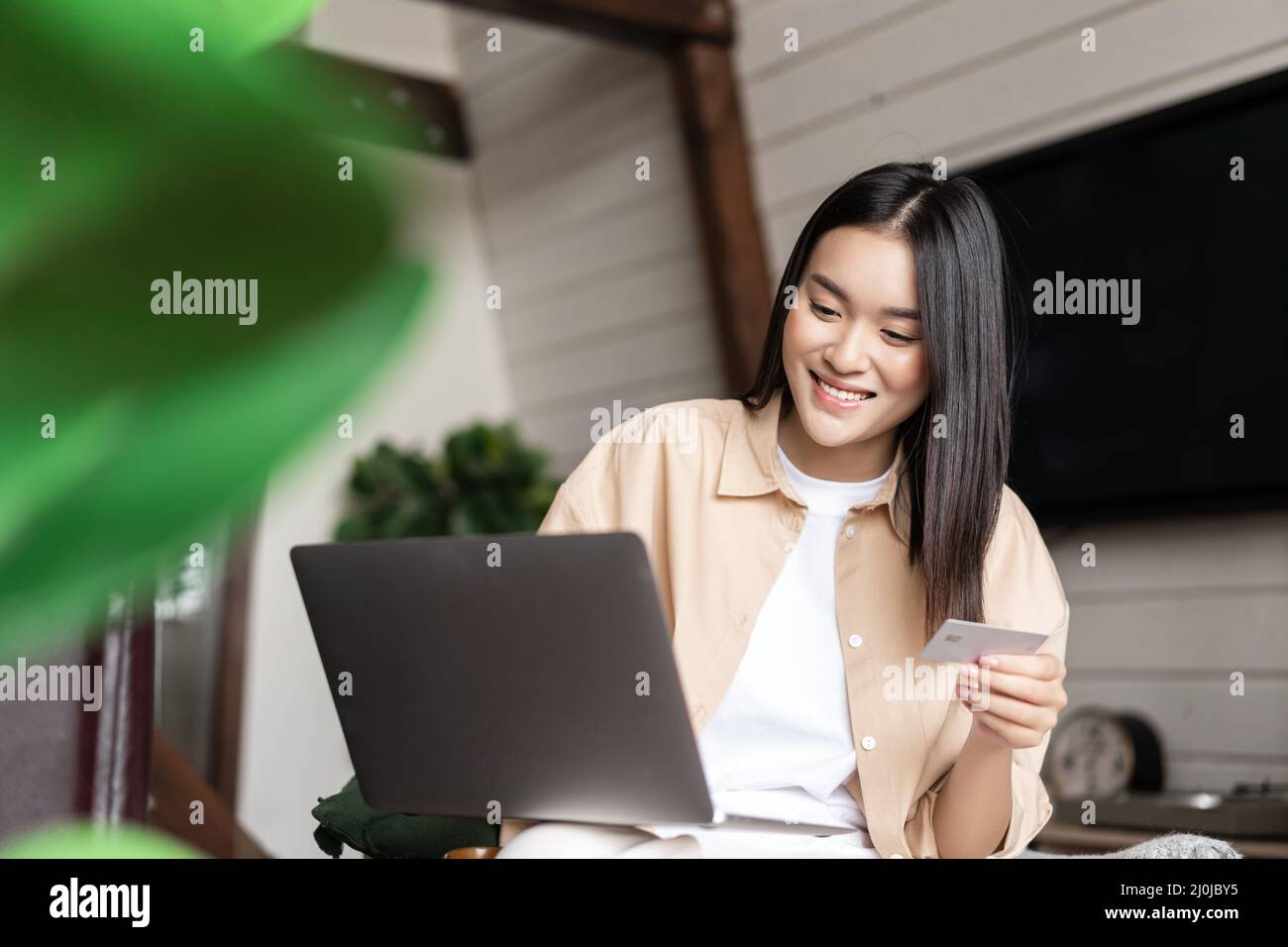 Image of korean woman buying smth online, paying with credit card on ...