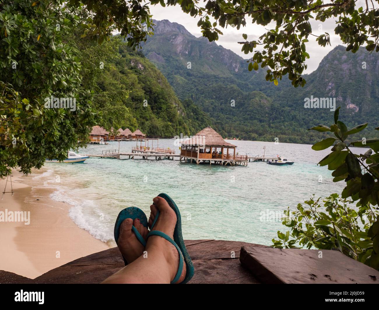 Ora Beach, Indonesia - Feb, 2018: Relax over the turquoise water. Woman ...