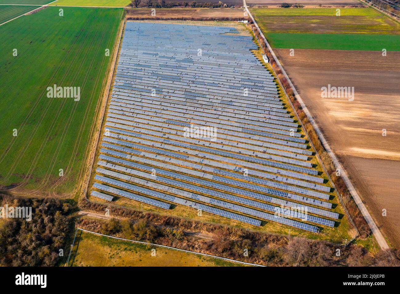Aerial view of a solar park with PV modules of a ground-mounted system ...