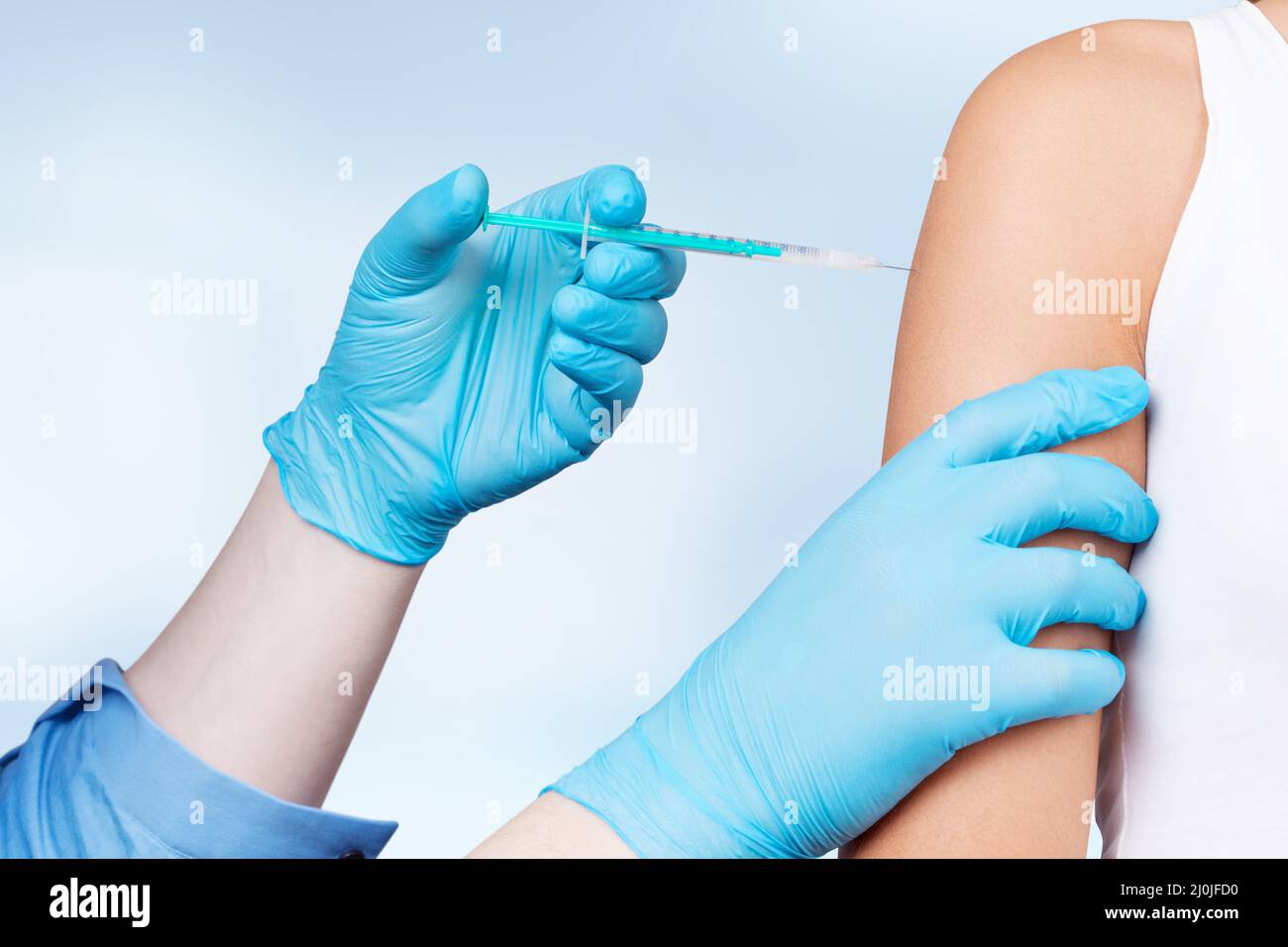 Doctor gives a syringe with vaccine to patient at clinic Stock Photo ...