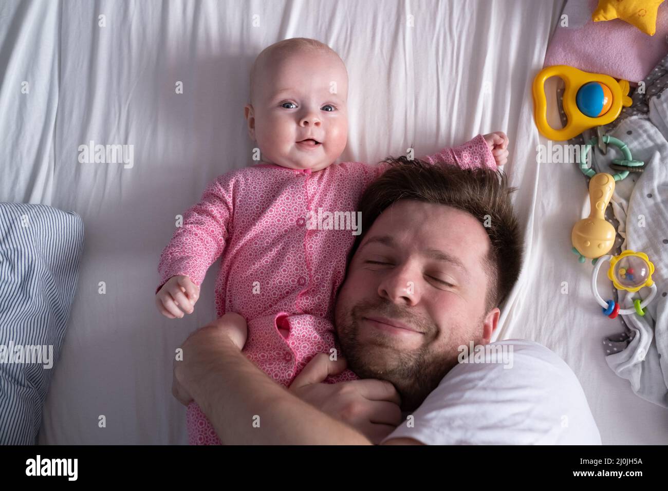 Caucasian father and cute child resting together in bed. Fatherhood concept Stock Photo - Alamy