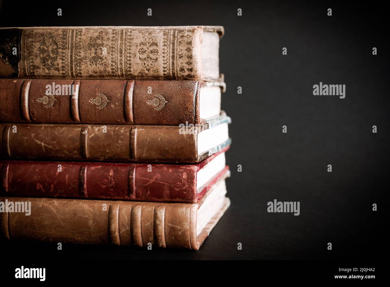 Stack of old books on black background Stock Photo - Alamy